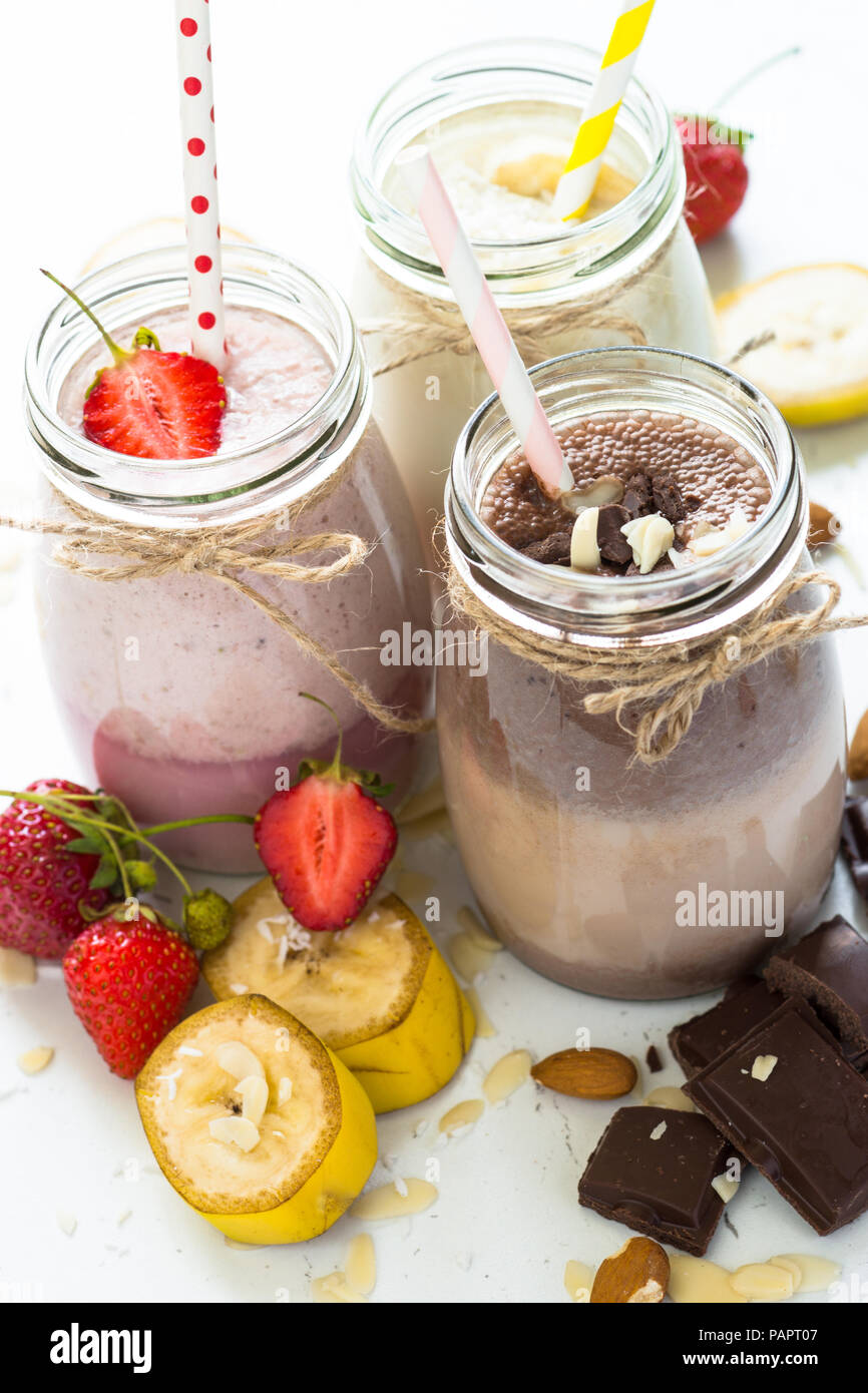 Set of milkshake in jars. Banana chocolate and strawberry milkshakes ...