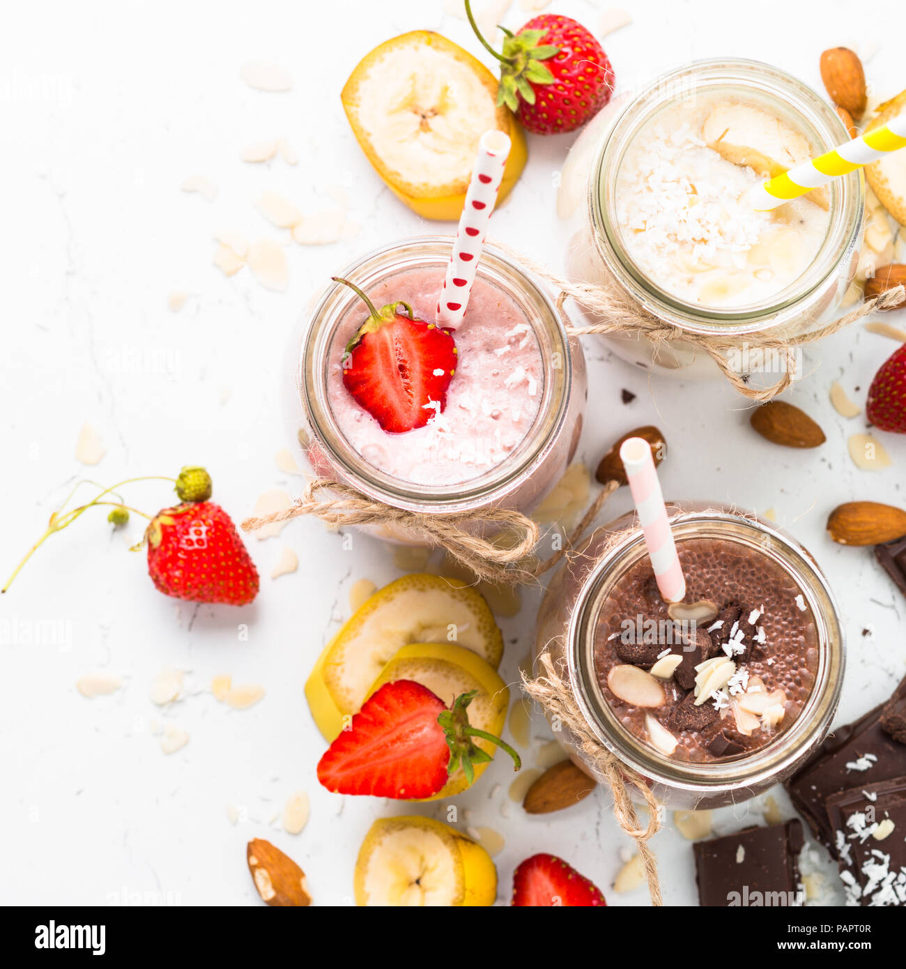 Set of milkshake in jars. Banana, chocolate and strawberry milkshakes ...