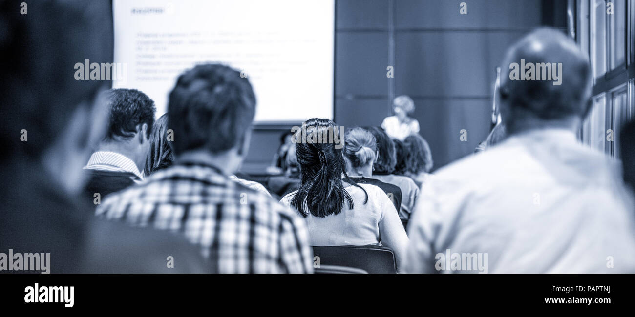 Woman giving presentation on business conference Stock Photo - Alamy