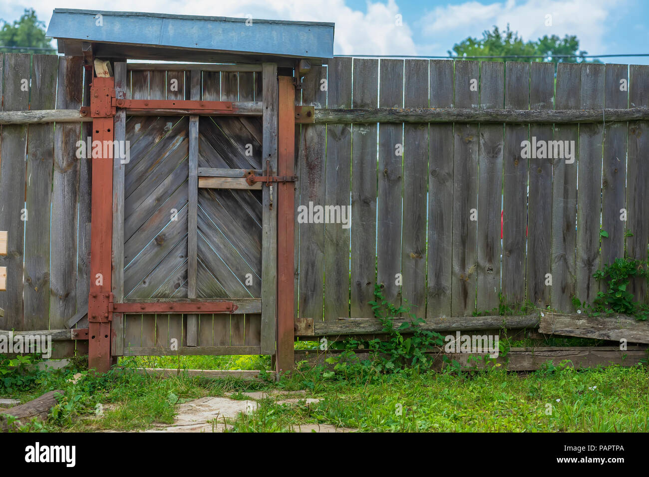 Old rustic wooden gate in natural village fence. Countryside rural ...