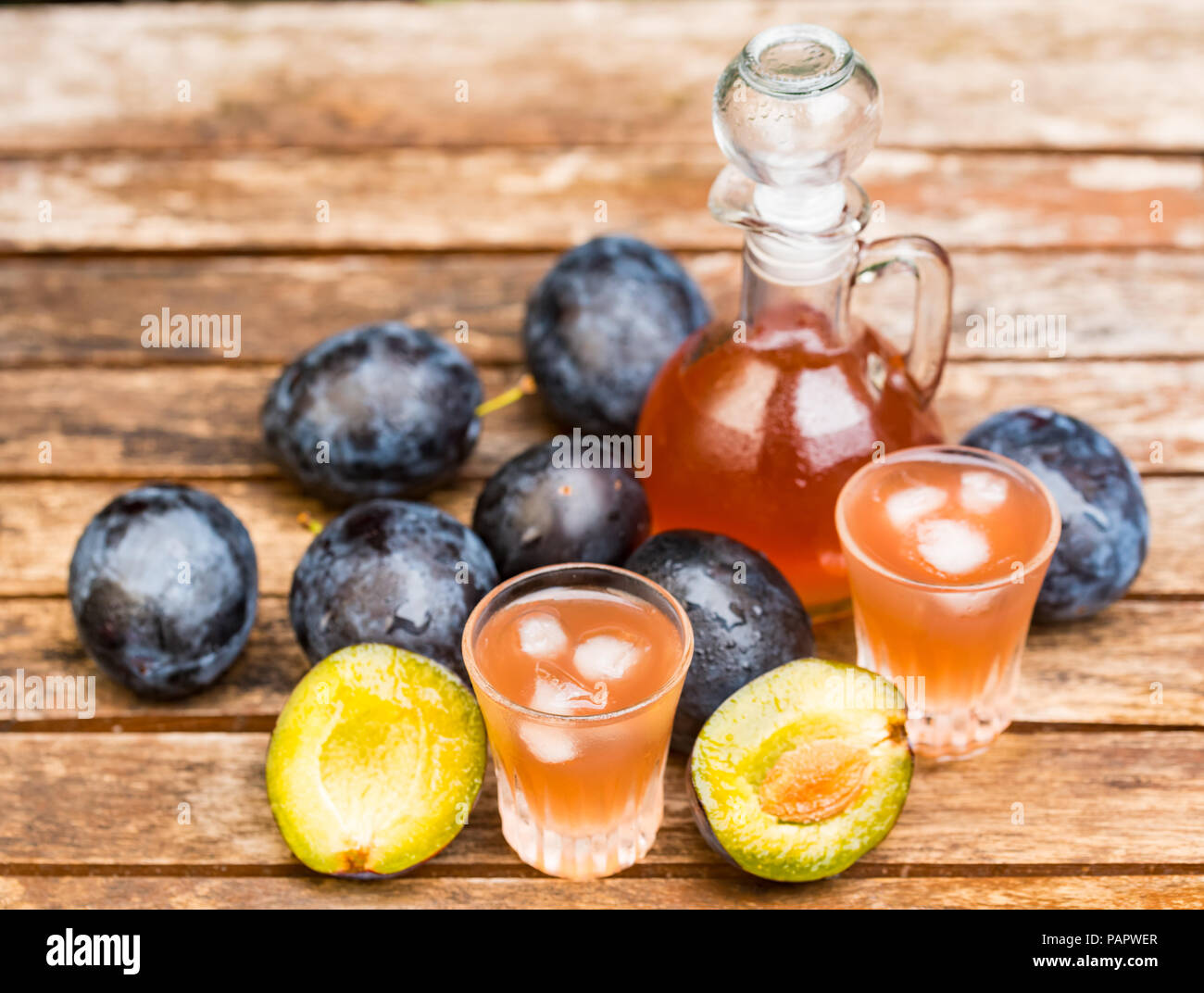 Plum brandy or slivovitz with fresh ripe plums Stock Photo - Alamy