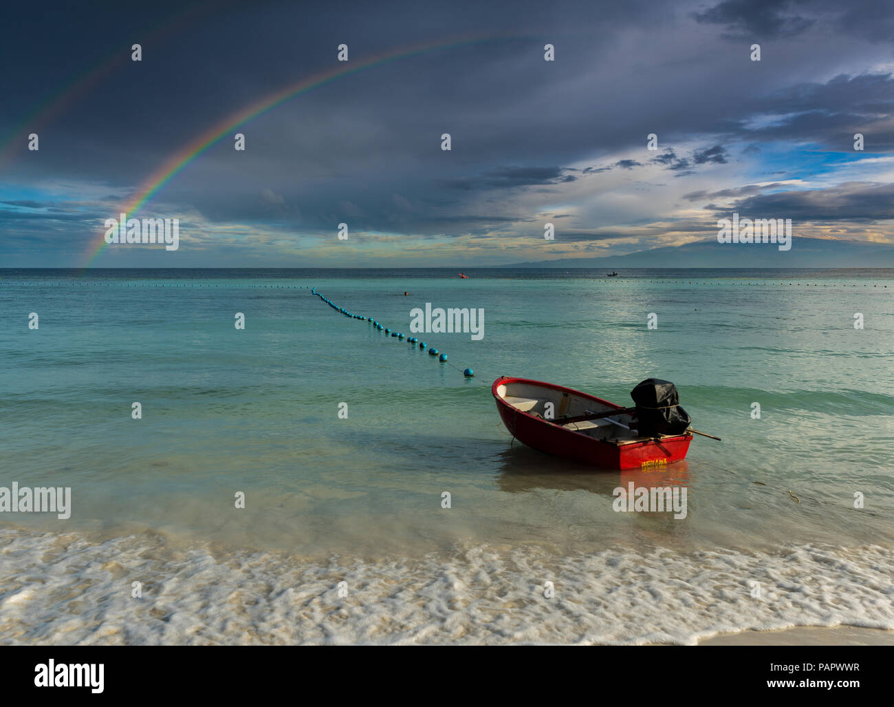 Small boat and rainbow Stock Photo - Alamy