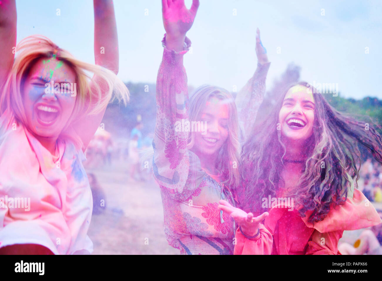 Crazy friends having fun with holi powder Stock Photo - Alamy
