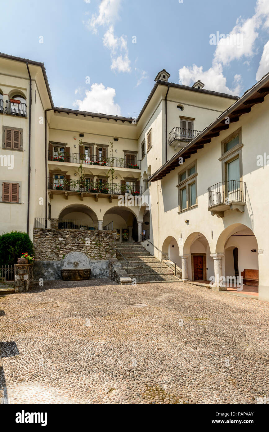 cityscape with old house and stone fountain, shot in bright summer ...