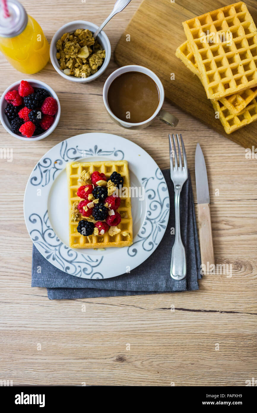 Waffle garnished with wild berries and muesli Stock Photo - Alamy