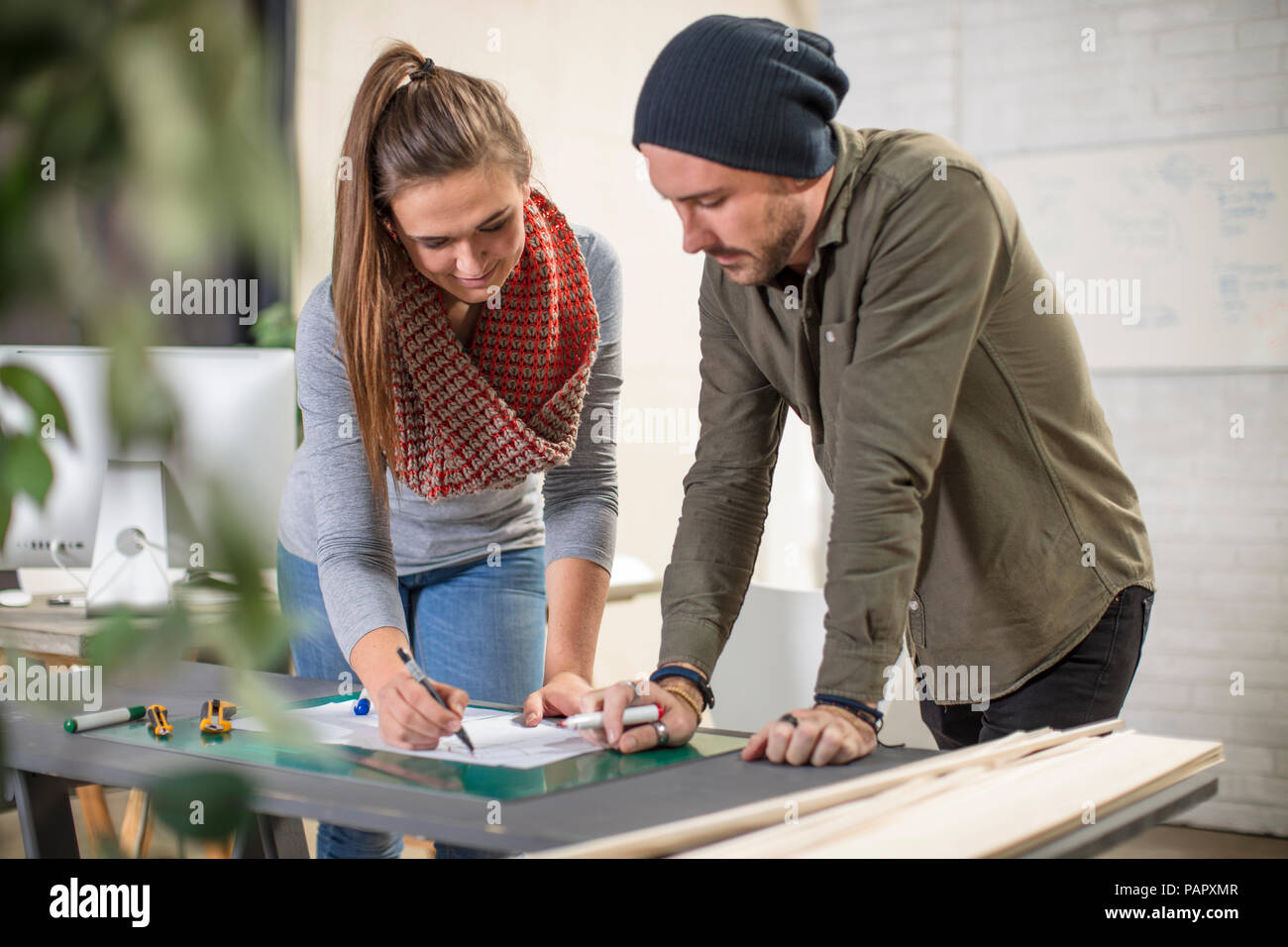 Collaborating office desk colleagues discussing hi-res stock ...