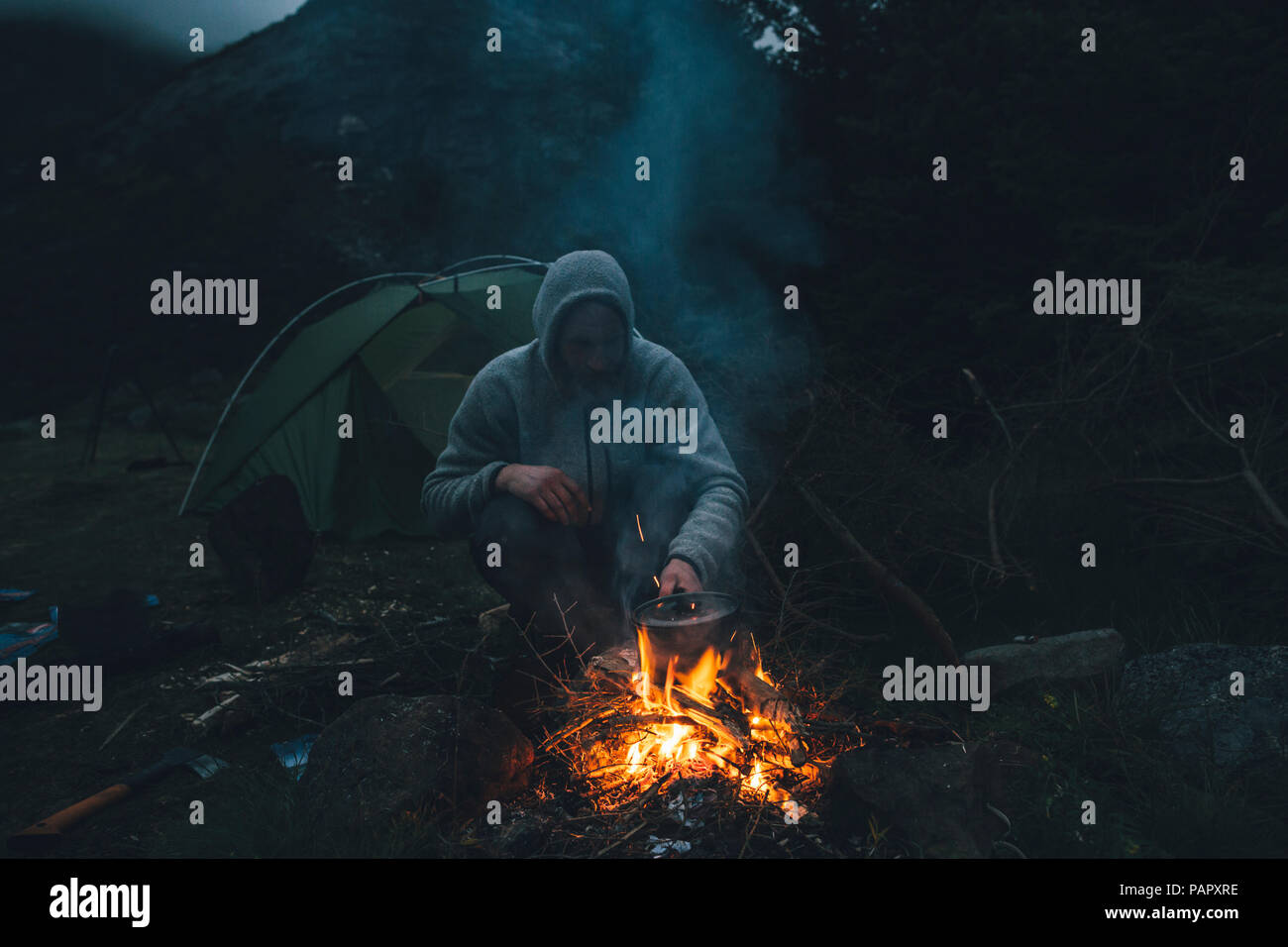 Person sitting by fire hi-res stock photography and images - Alamy