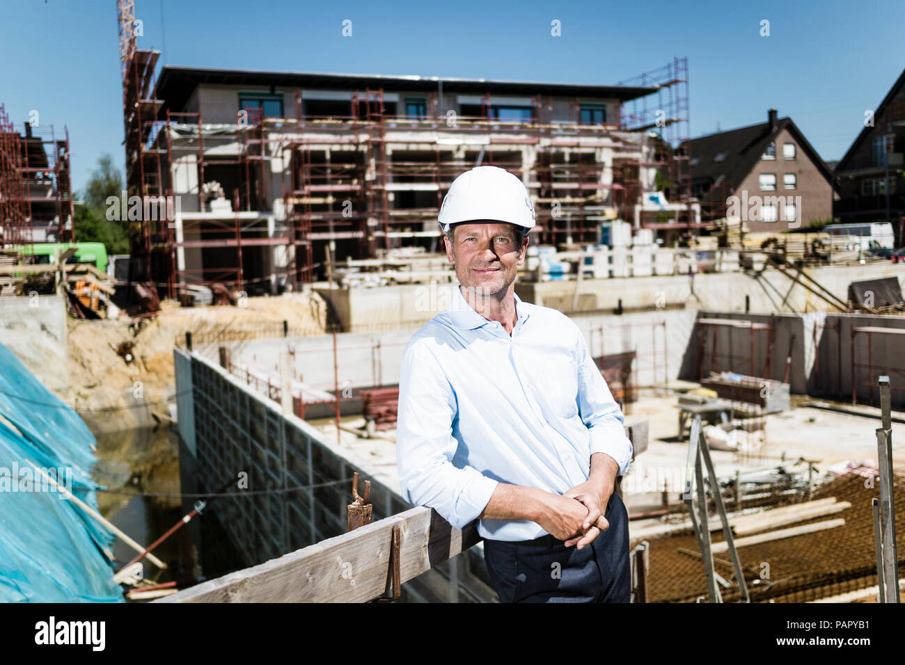 Portrait of confident man wearing hard hat on construction site Stock ...