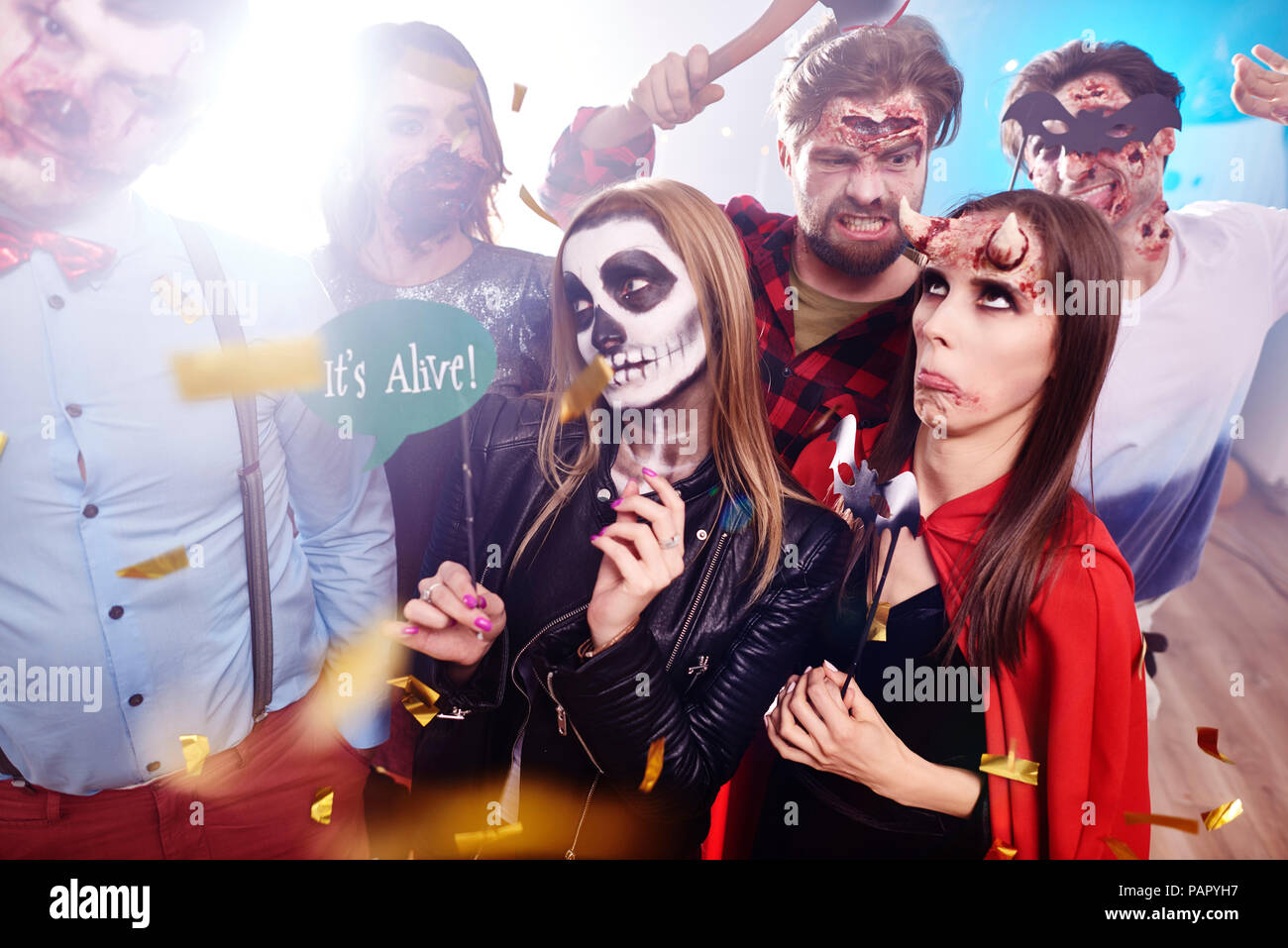 Friends in creepy costumes having fun at Halloween party Stock Photo ...