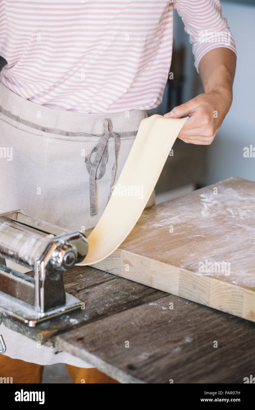 Woman preparing homemade pasta, using pasta maker Stock Photo - Alamy