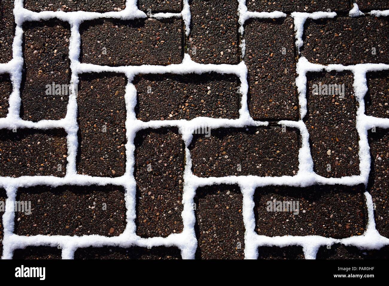 Block paving with snow between the bricks, England, UK, Western Europe ...