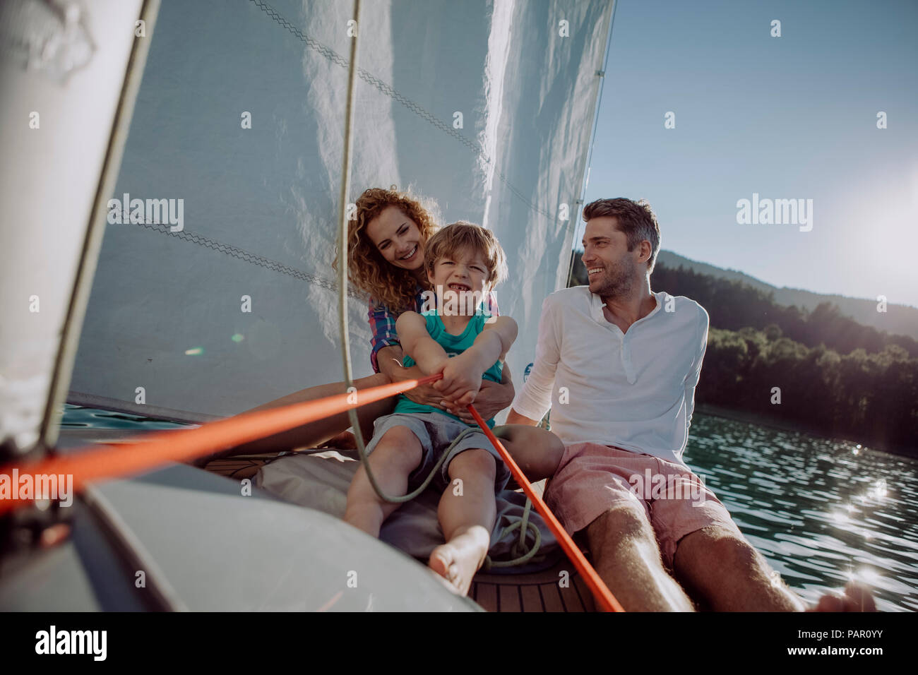 Happy family on a sailing boat Stock Photo - Alamy