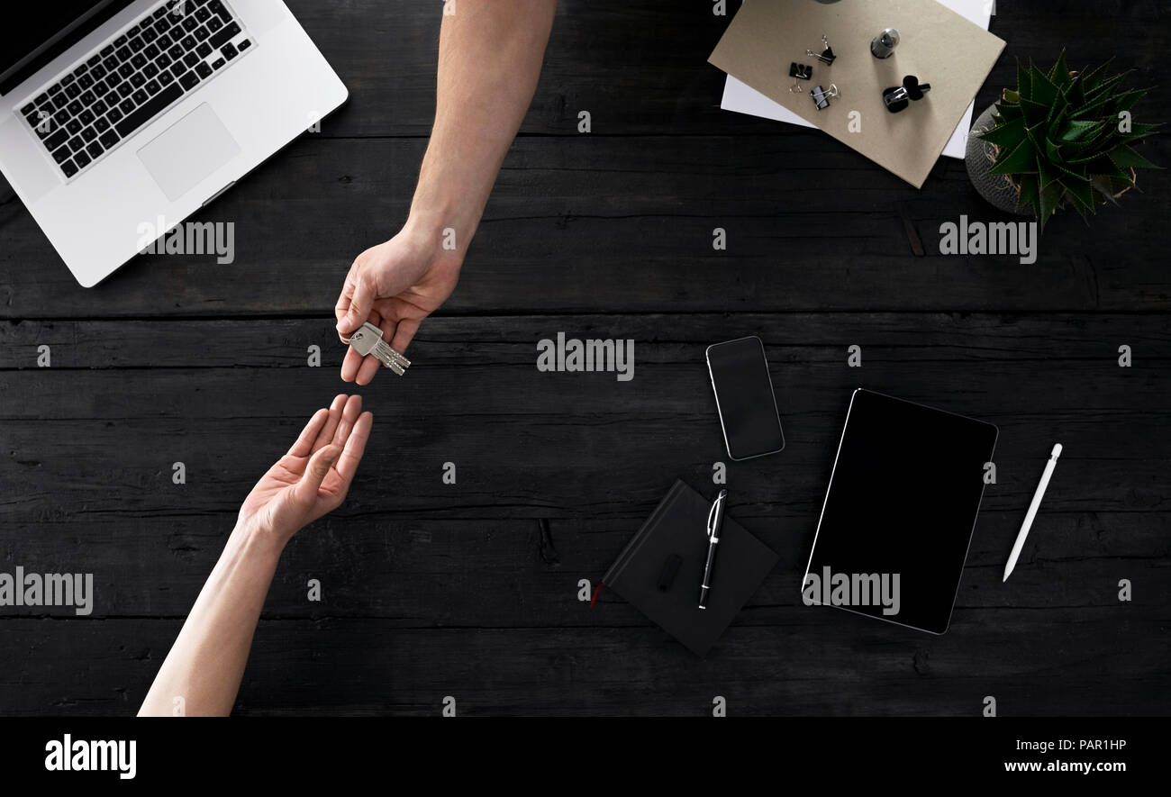 People handing over keys in office Stock Photo - Alamy
