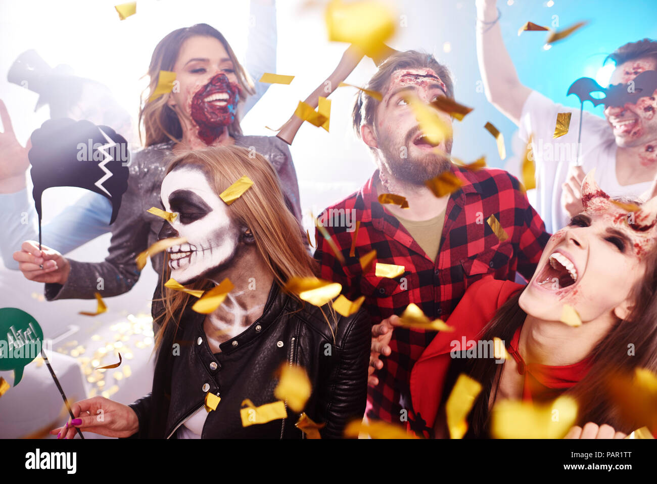 Friends in creepy costumes having fun at Halloween party Stock Photo ...