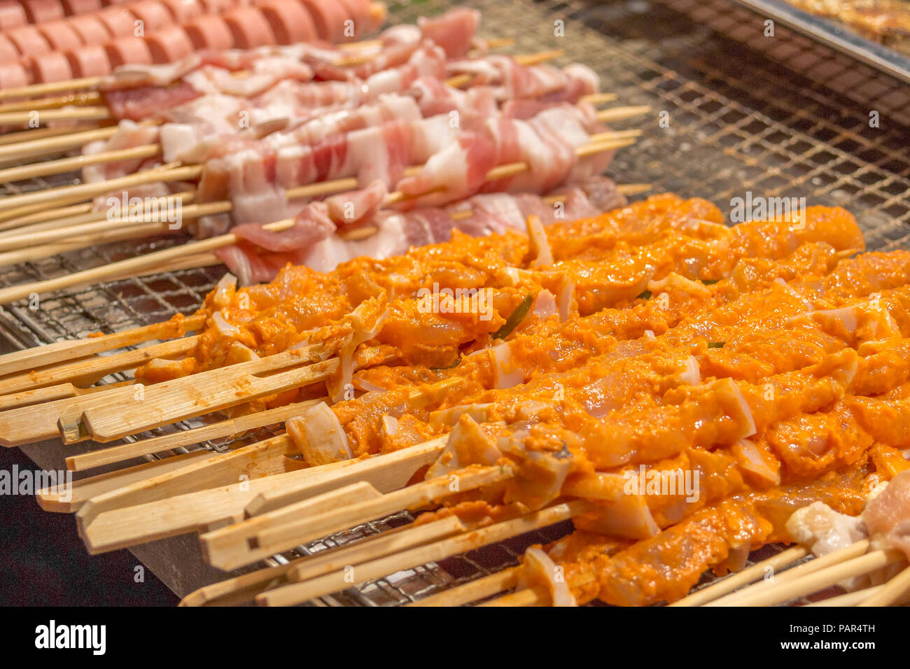 Meat roasting on wooden stick hi-res stock photography and images - Alamy