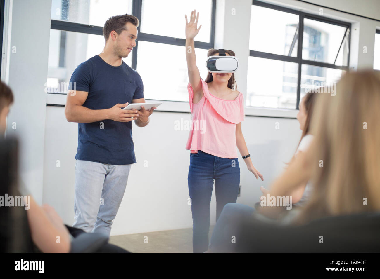 Teacher with tablet student wearing VR glasses in class Stock Photo - Alamy