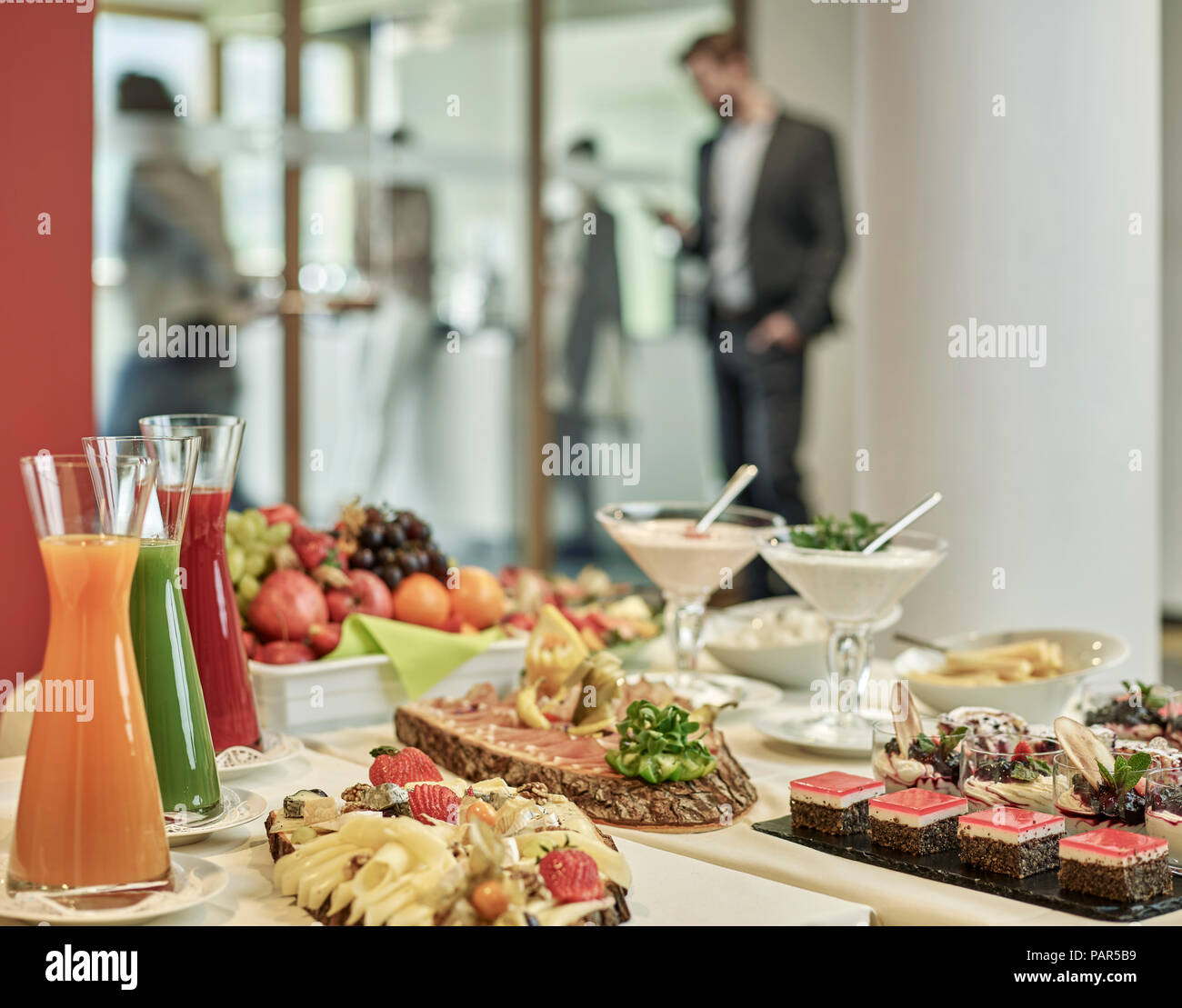 Buffet with appetizers and business people in background Stock Photo ...