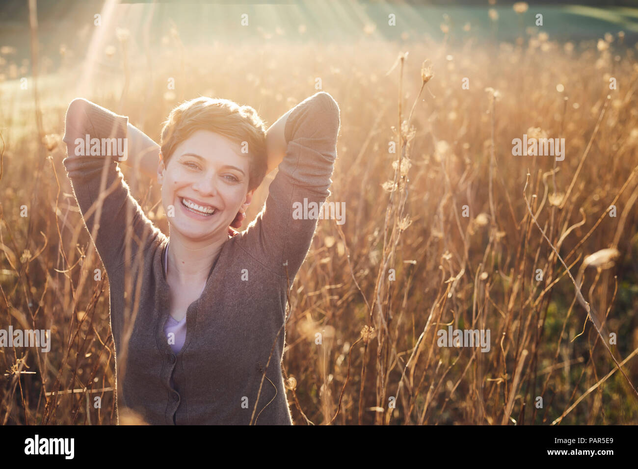 Portrait of laughing woman relaxing in nature Stock Photo - Alamy