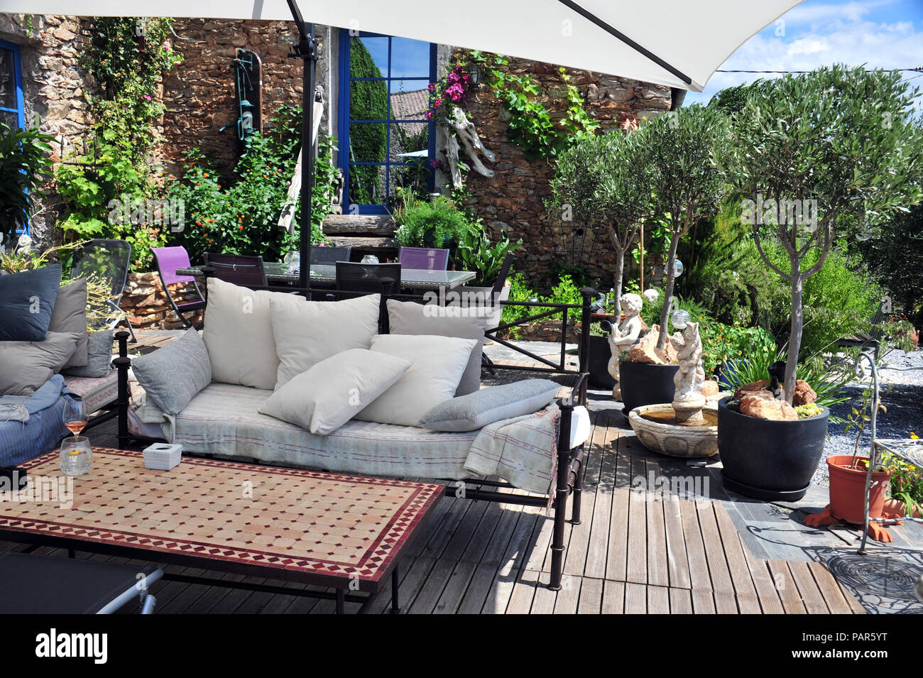 Seating area and coffee table outside in a pretty courtyard hi-res ...