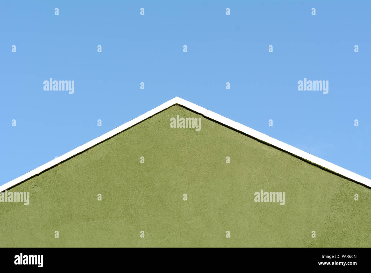 Pitched roof with green painted render Stock Photo - Alamy