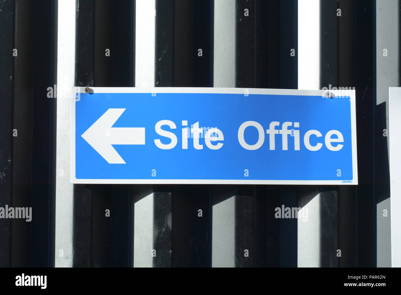 Site Office sign with direction arrow on wall at construction site ...