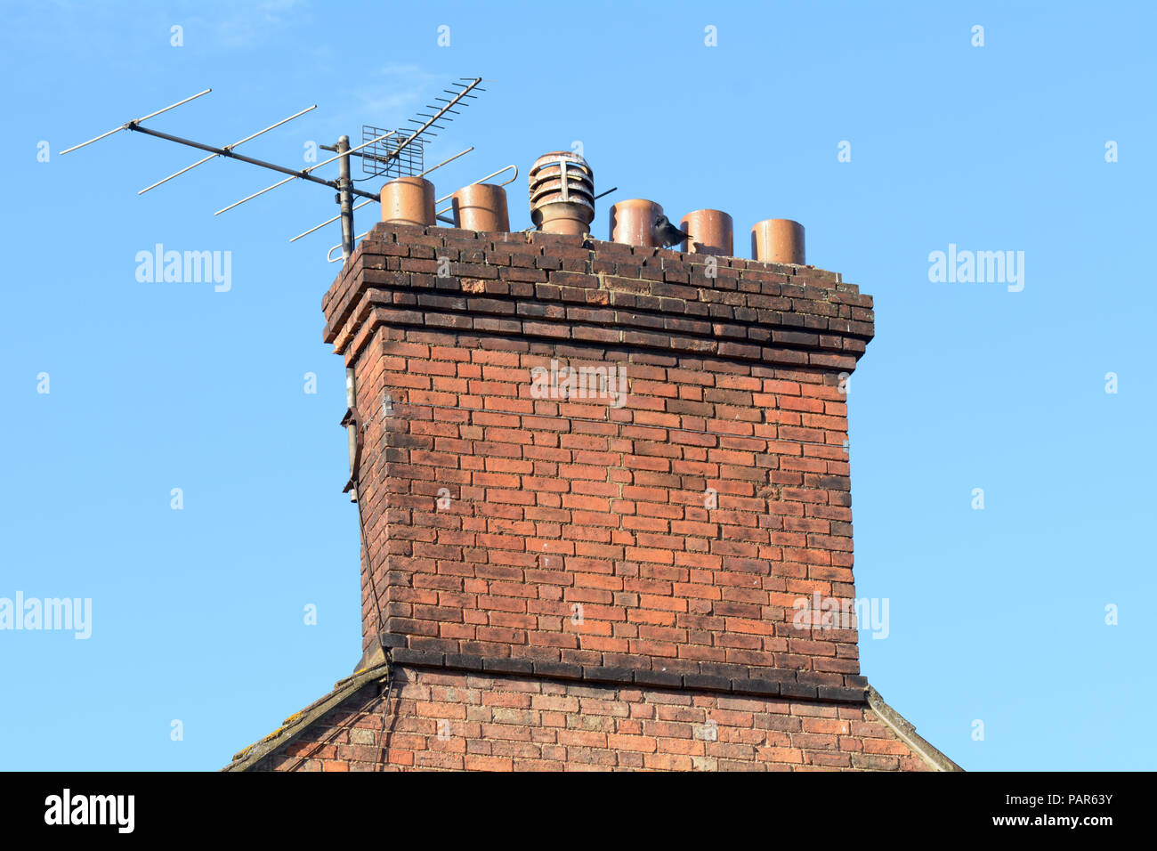 Chimney stack and tv aerial on roof of Victorian style property Stock ...