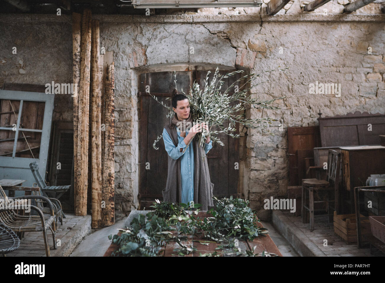 Woman arranging twigs Stock Photo - Alamy