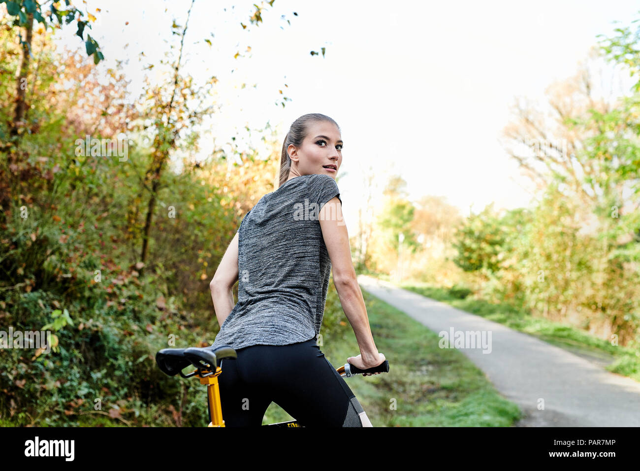 Woman bicycle rear view hi-res stock photography and images - Alamy