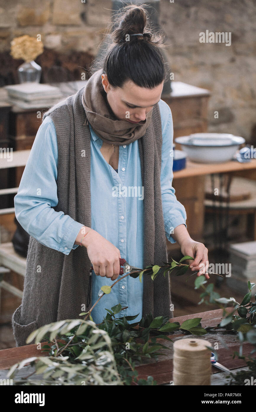 Woman arranging twigs Stock Photo - Alamy