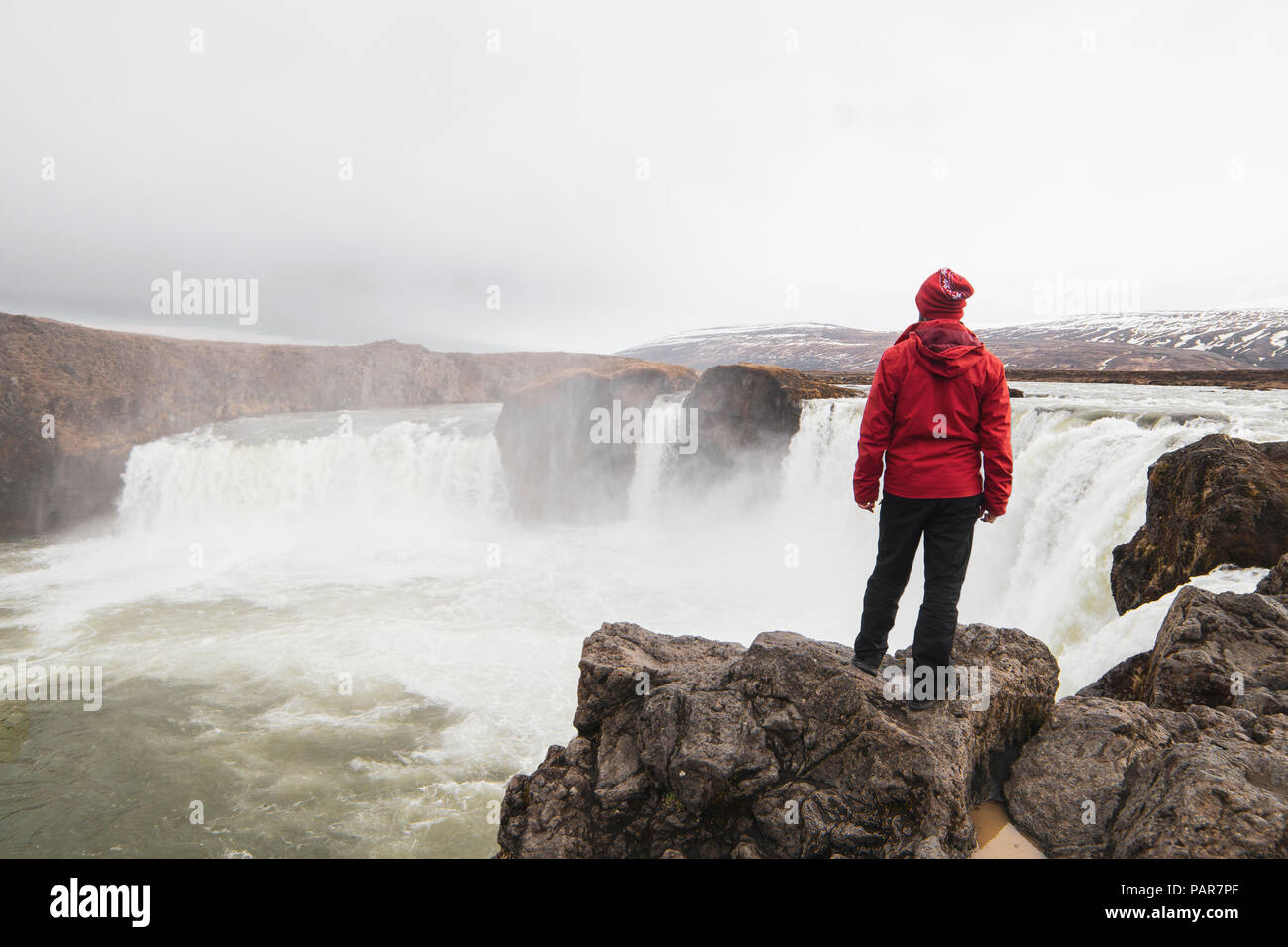 Iceland, man standing at Godafoss waterfall Stock Photo - Alamy