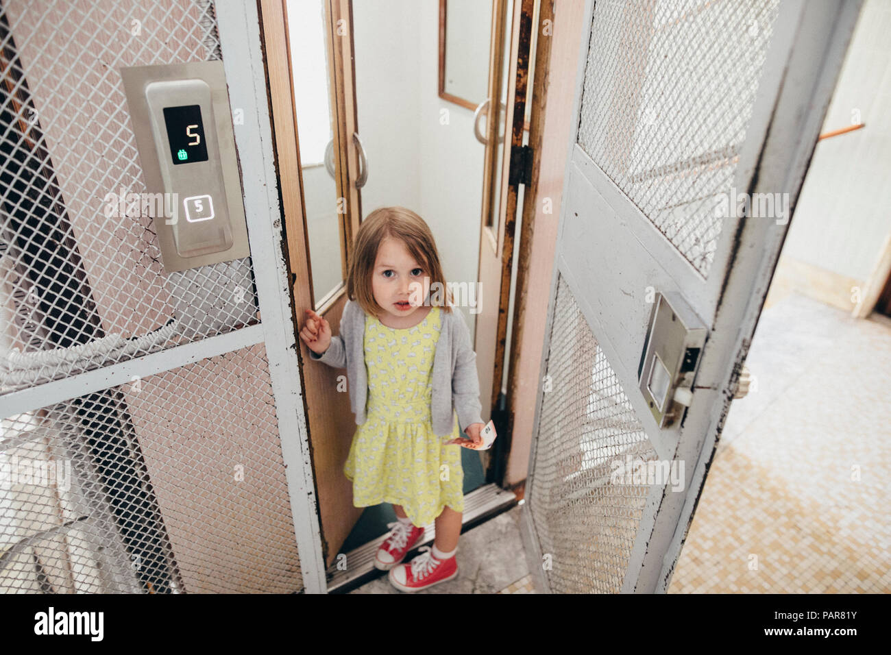 Portrait of little girl leaving lift Stock Photo - Alamy