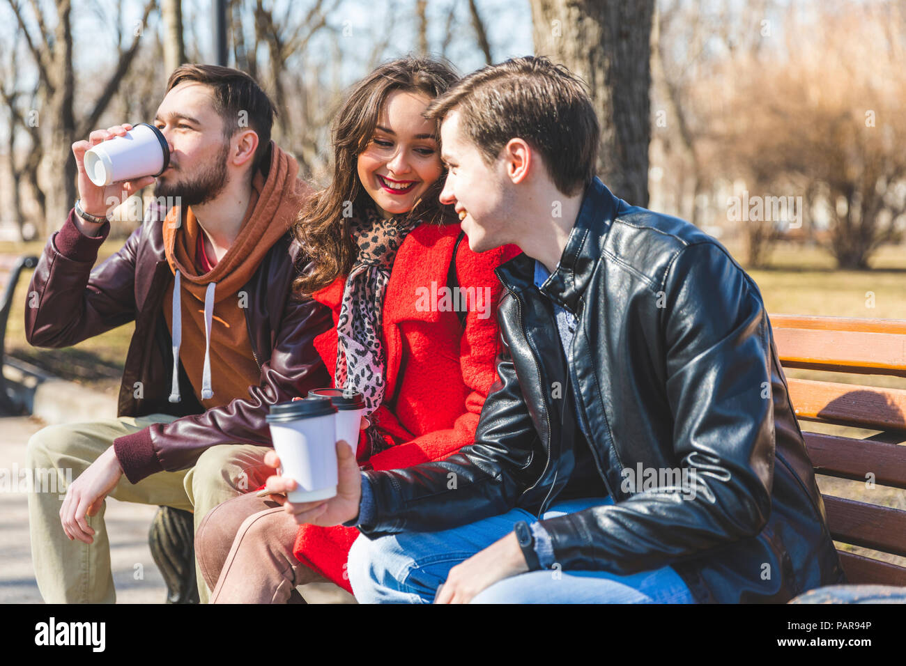 Russia, Moscow, group of friends at park having fun together, drinking ...