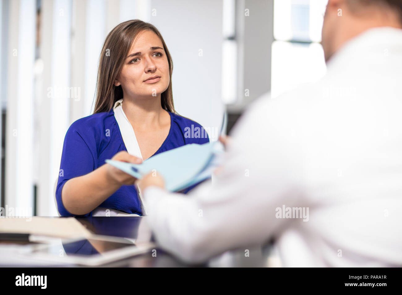 Doctor giving patient documents hi-res stock photography and images - Alamy