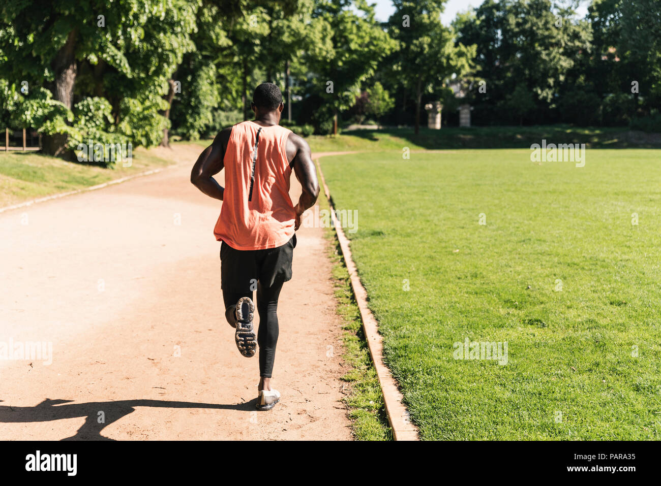 Young athlete on sports field training running Stock Photo - Alamy