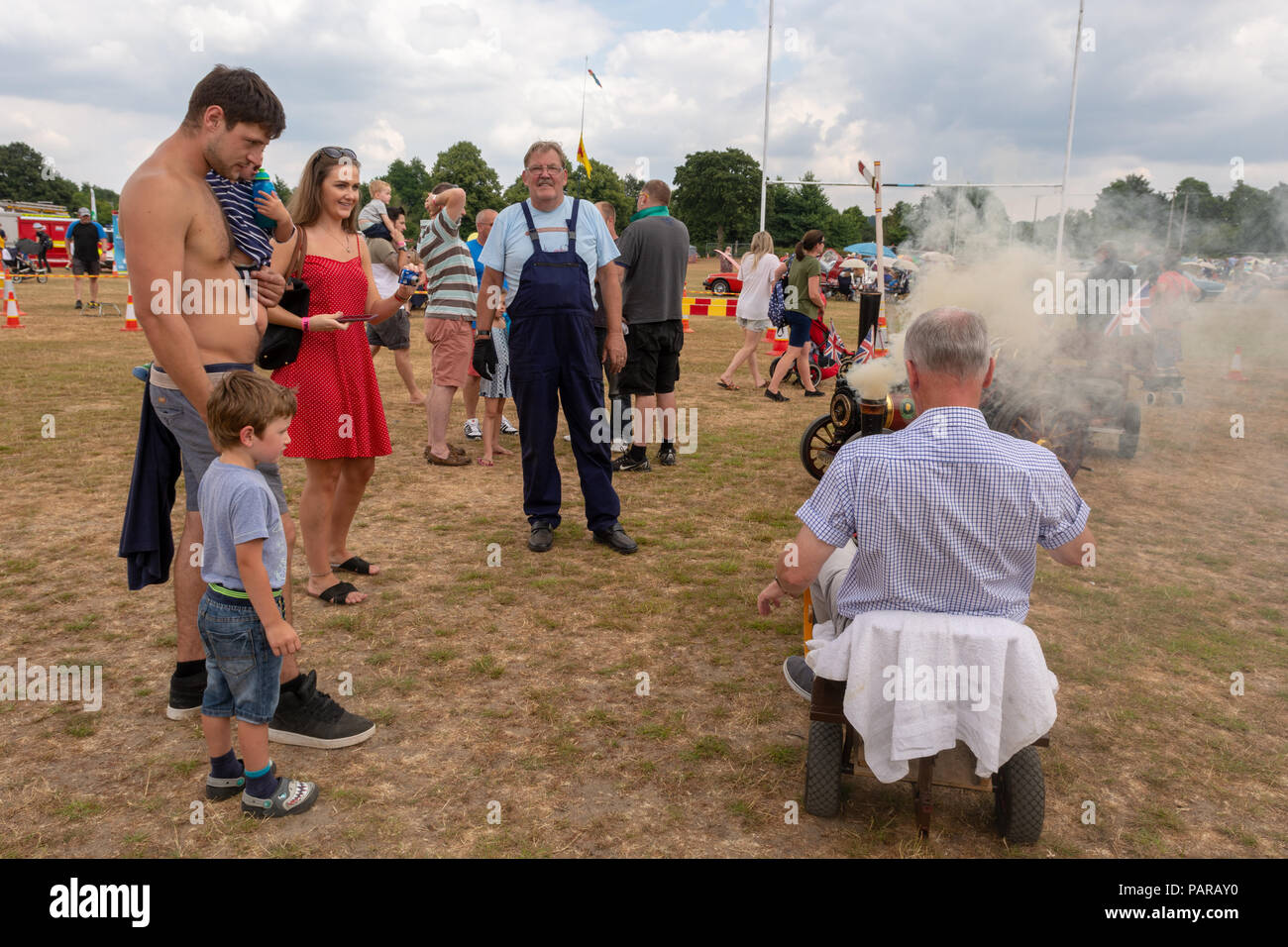 People watching a steam engine demonstration at a country fair in ...