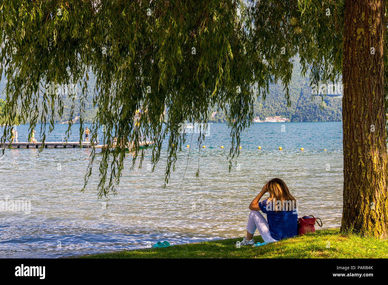 Woman relaxing under tree hi-res stock photography and images - Alamy