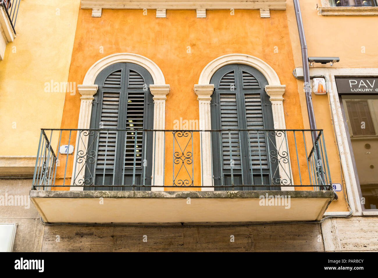 bright yellow mustard, italian balcony, with double windows, and closed ...