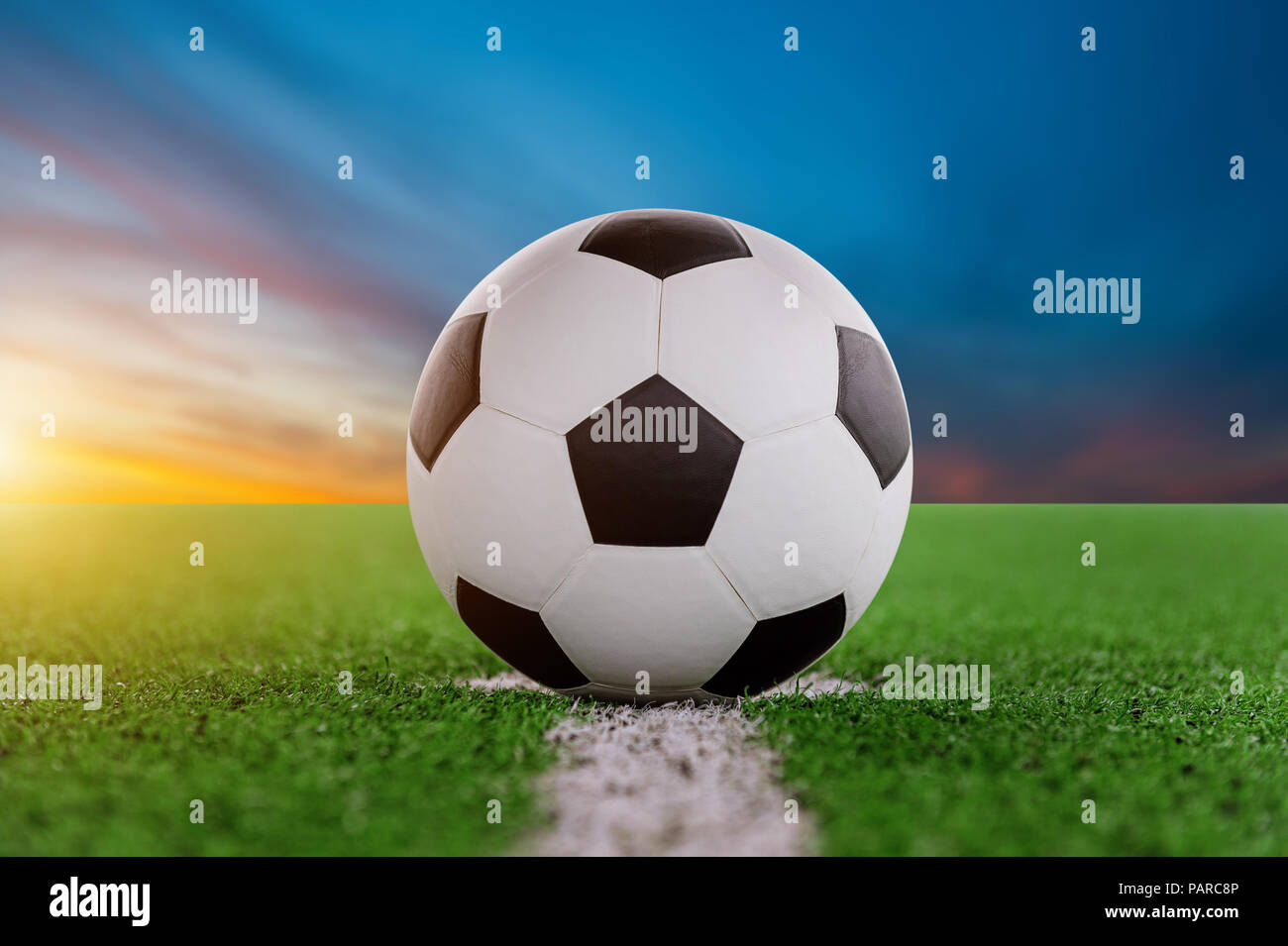 soccer ball on soccer field at sunset Stock Photo - Alamy