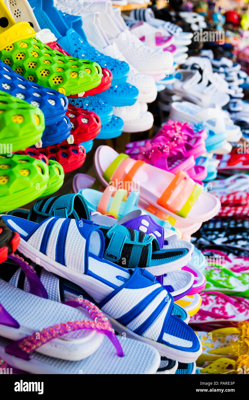 Beach shoes in the store. sandals on the beach Stock Photo - Alamy