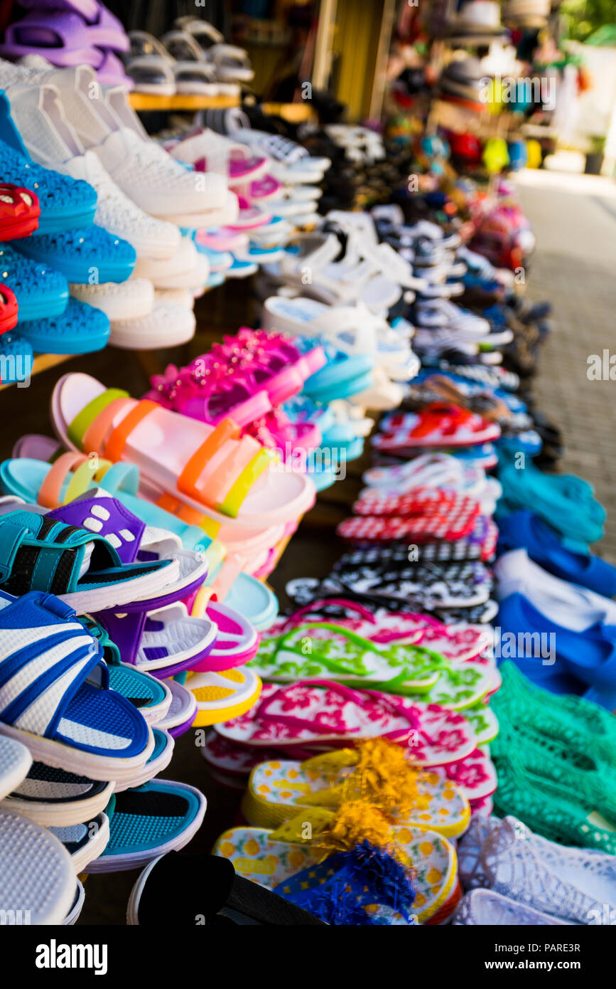 Beach shoes in the store. sandals on the beach Stock Photo - Alamy