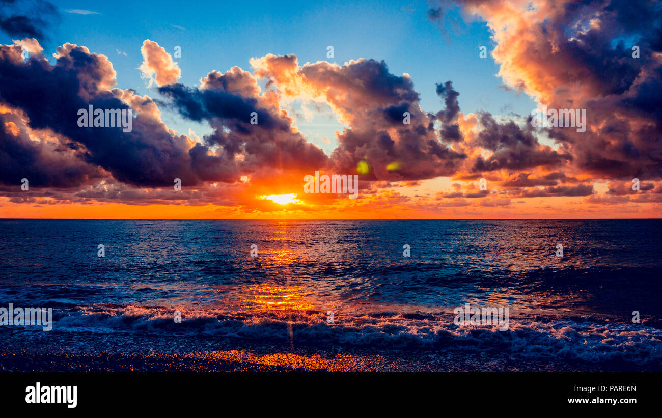 Colorful sunset over ocean Stock Photo - Alamy