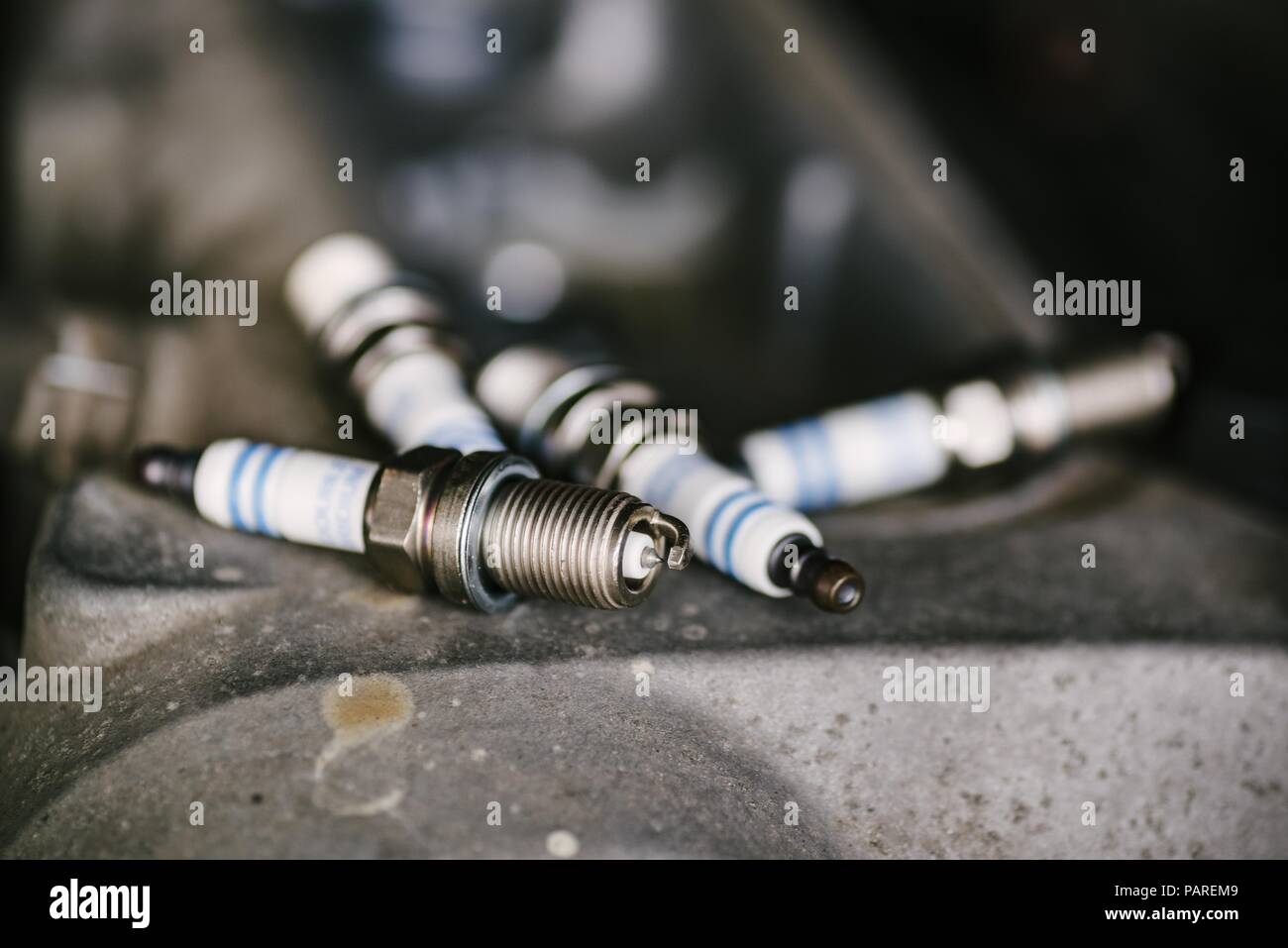 New car spark plugs. Car repair. Replacement of spark plugs Stock Photo - Alamy