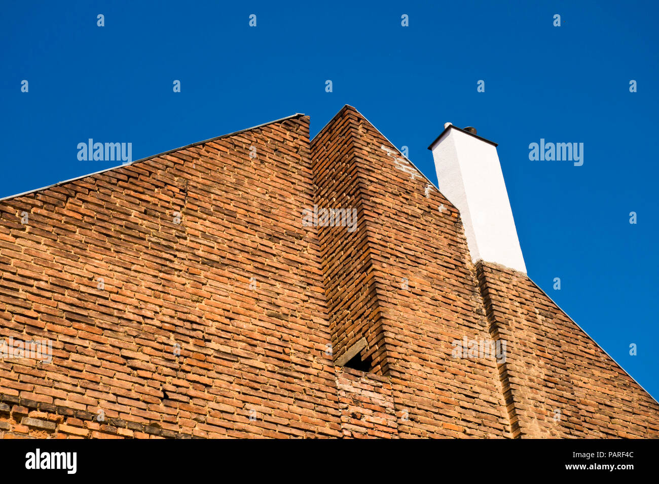 graphical angled view of a red bricks house with white chimney and blue ...