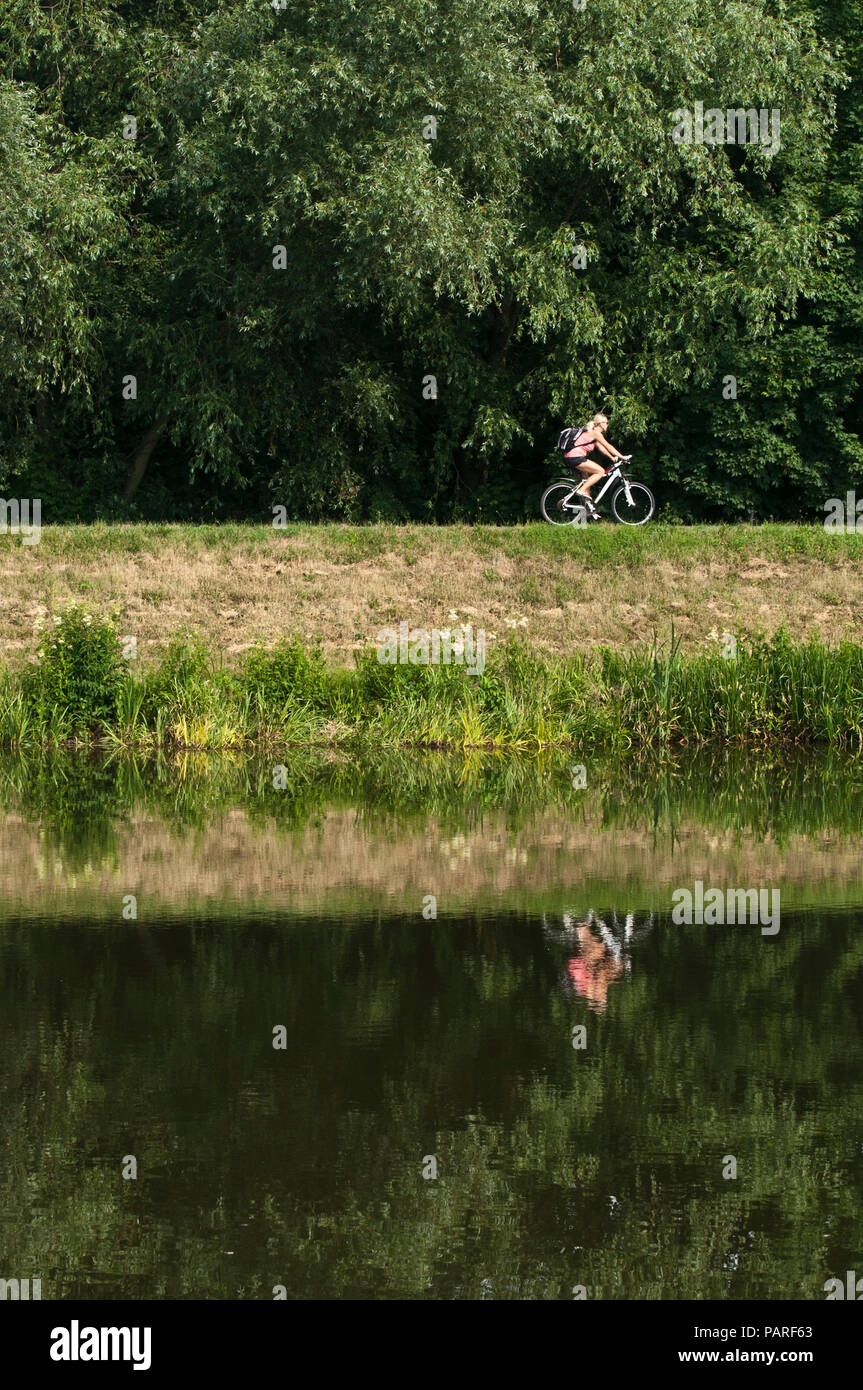Woman riding a bicycle hi-res stock photography and images - Alamy