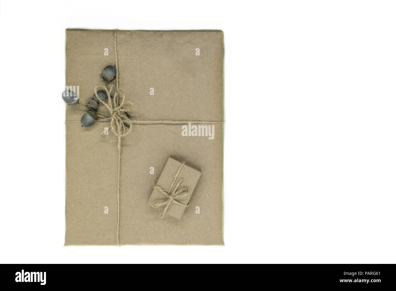 Composition of gift boxes wrapped in beige paper and bundled with ...