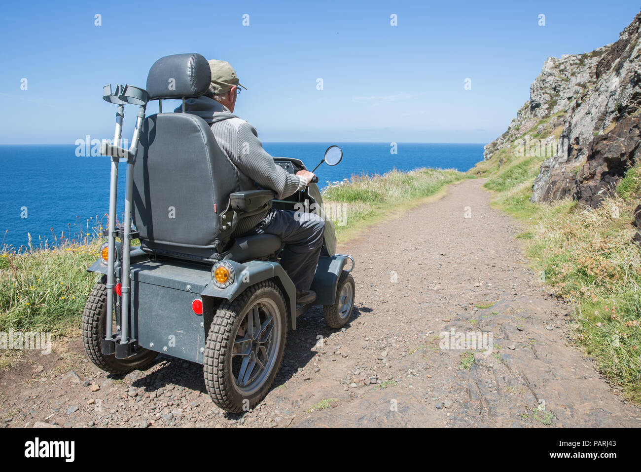 Old man on mobility scooter hi-res stock photography and images - Alamy