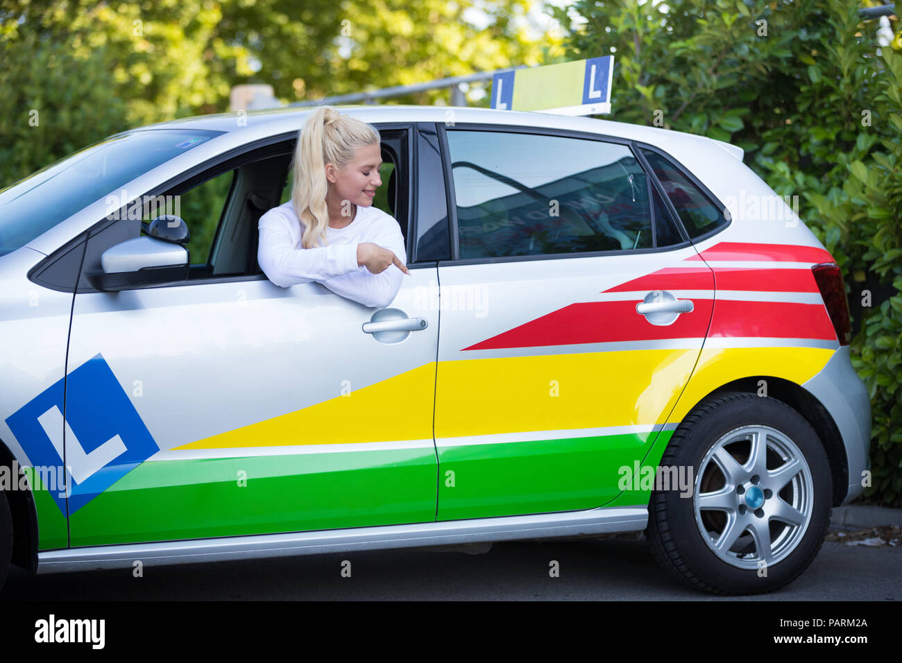 Driving school. Young happy woman or driving student sitting and ...
