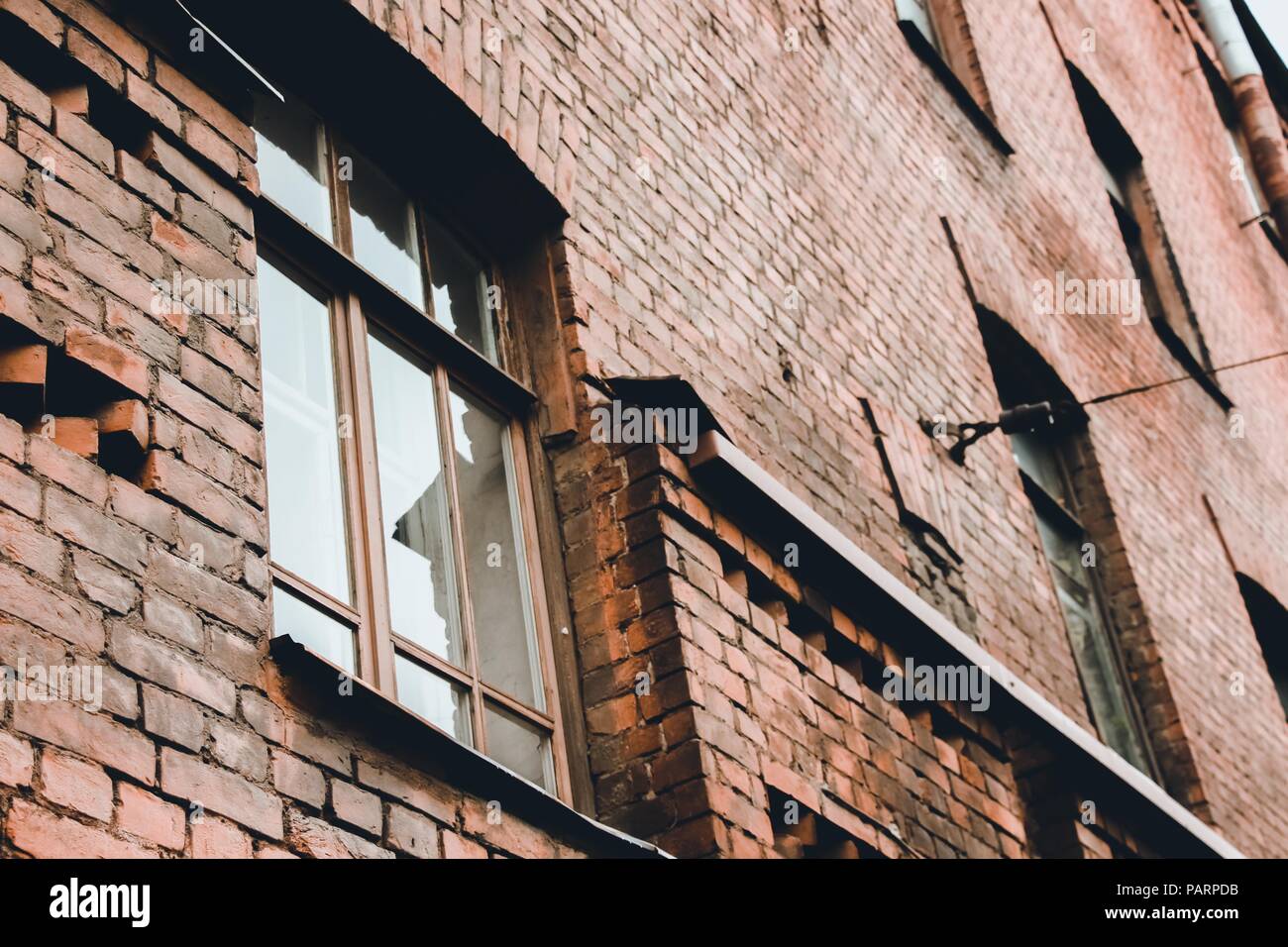 Large windows in an old brick building. The building was built in the ...