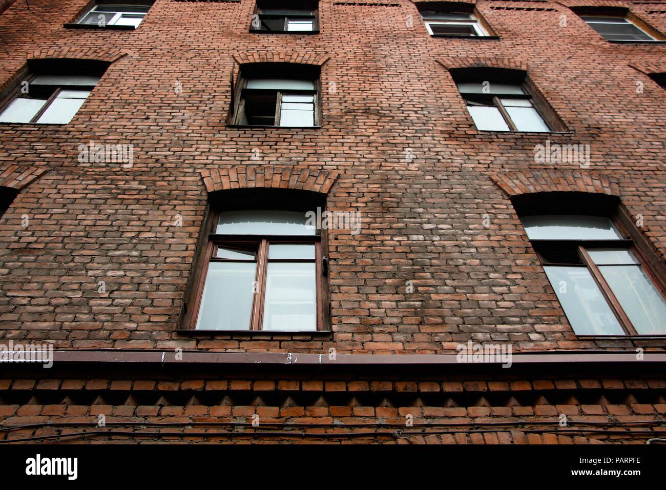 Large windows in an old brick building. The building was built in the ...