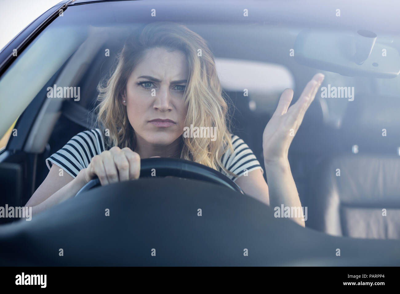 Angry woman driving a car Stock Photo - Alamy